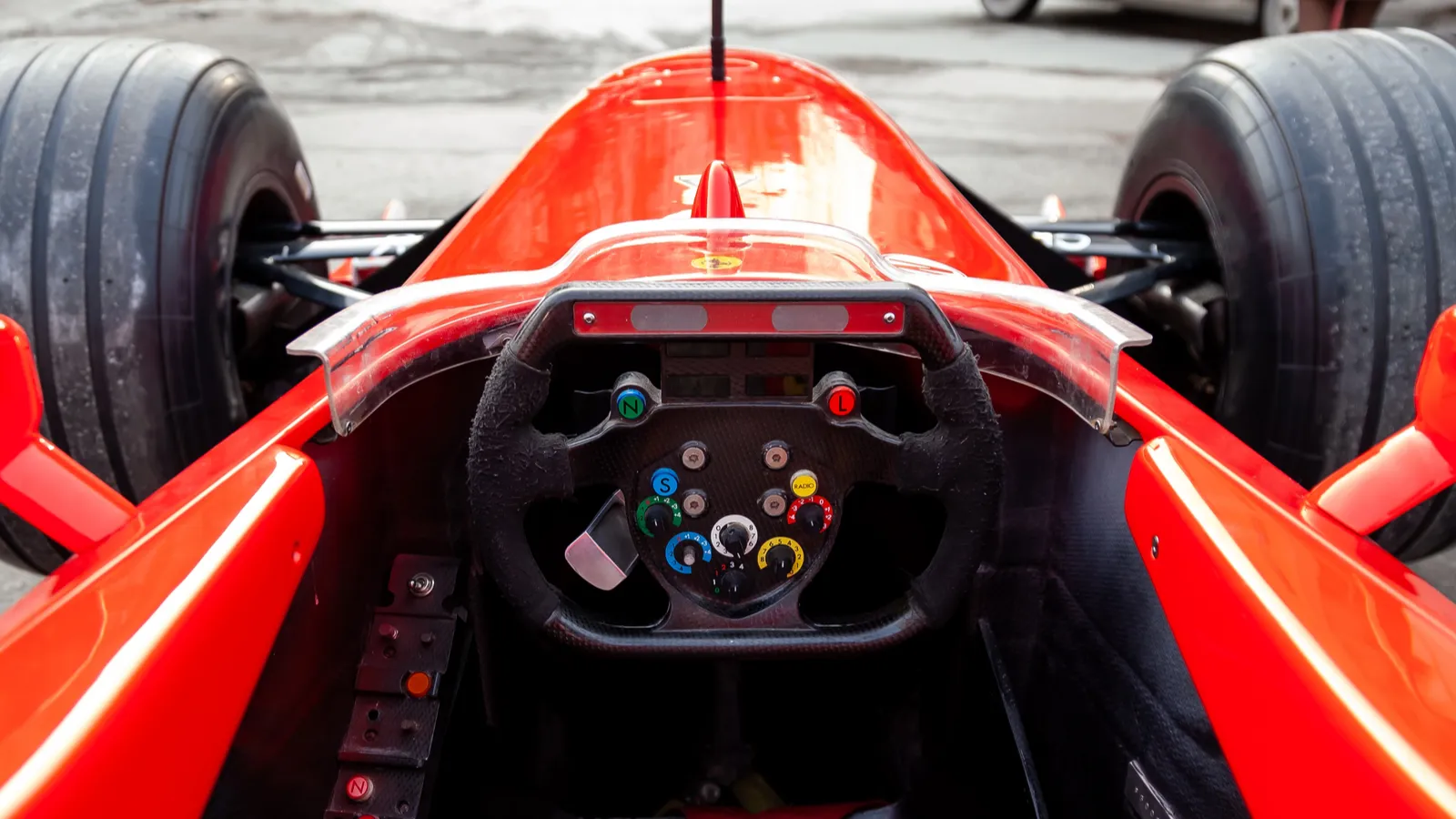 cockpit and steering wheel view of red ferrari racing sports - NashvilleGab